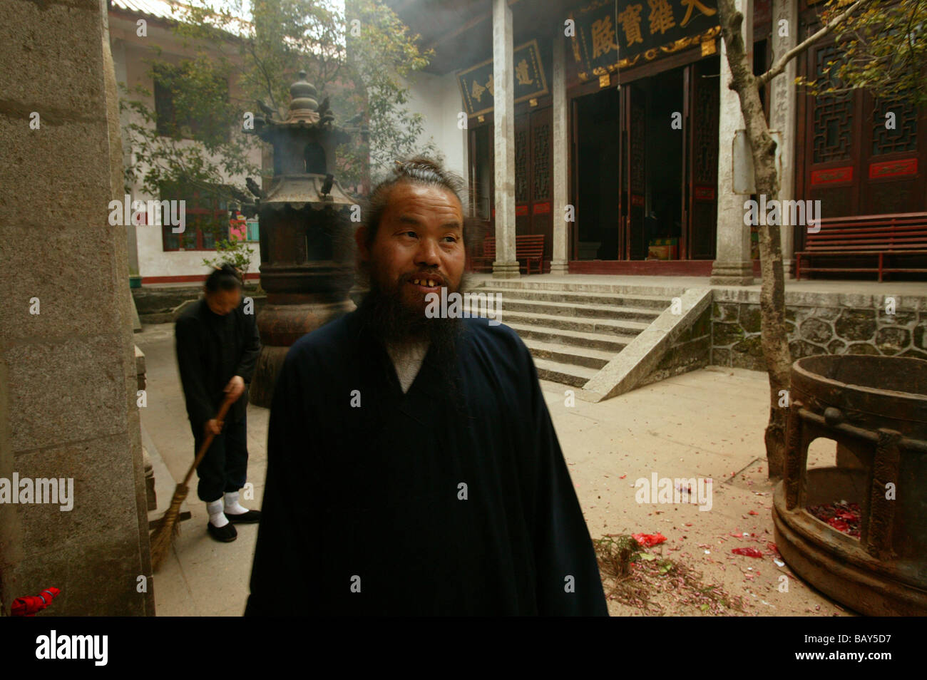 A monk standing at the courtyard of Xuandu monastery, Heng Shan South ...
