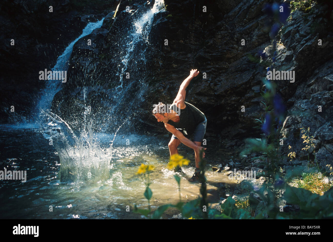 A man standing at a waterfall Stock Photo - Alamy