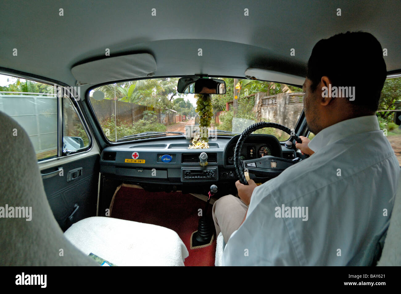 India, Kerala. Going by a typical traditional indian "Ambassador" taxi ...