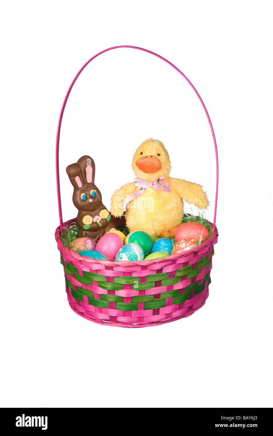 An Easter basket with colored eggs a chocolate bunny and a stuffed toy ...