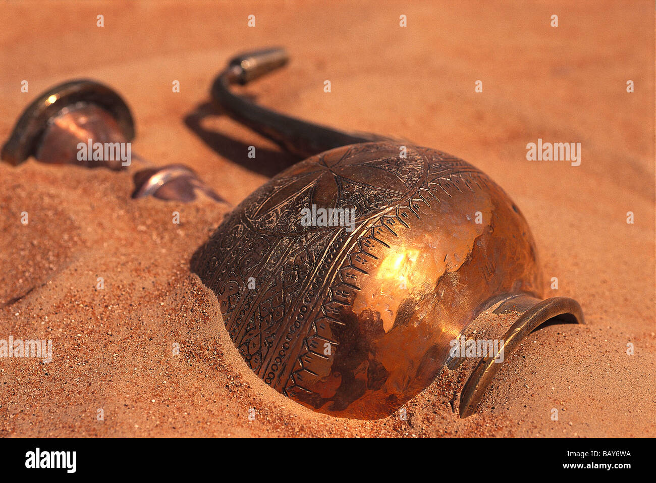 Copper can lying in the sand of the desert, Dubai, United Arab Emirates ...