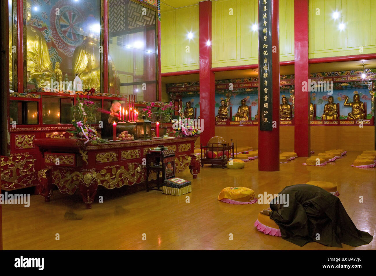 Praying monk at main hall of the Wannian monastery, Emei Shan, Sichuan ...