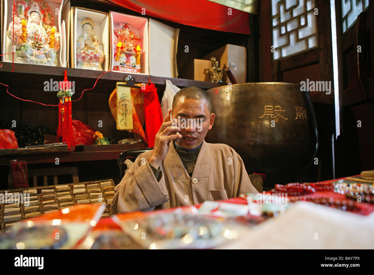 Monk with mobile phone at the entrance of temple, Zhu Rong Feng, Heng ...