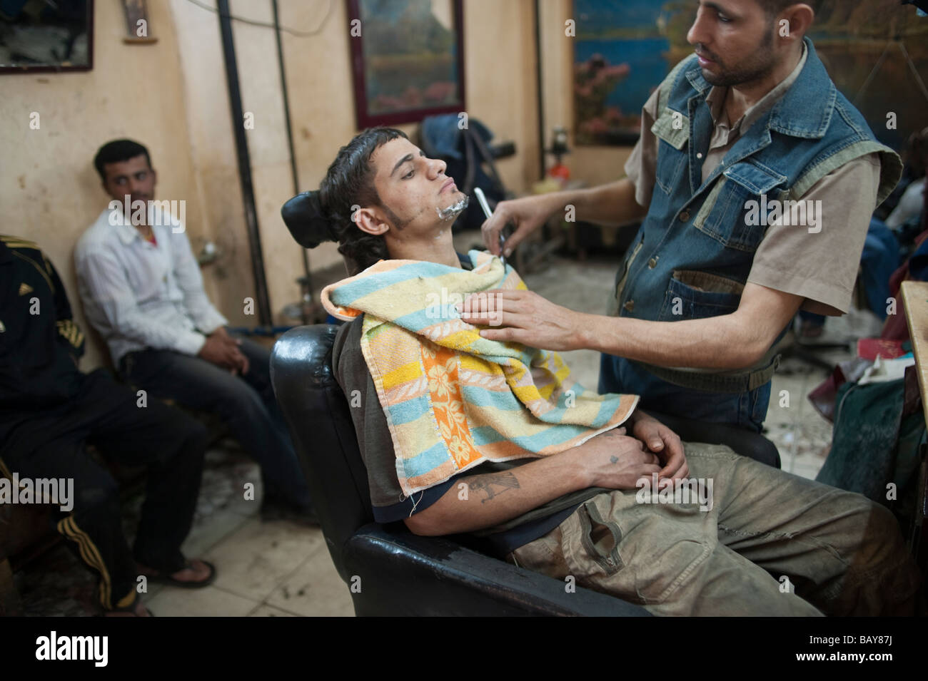 Barber in Cairo's Coptic Christian district preparing his customers for ...