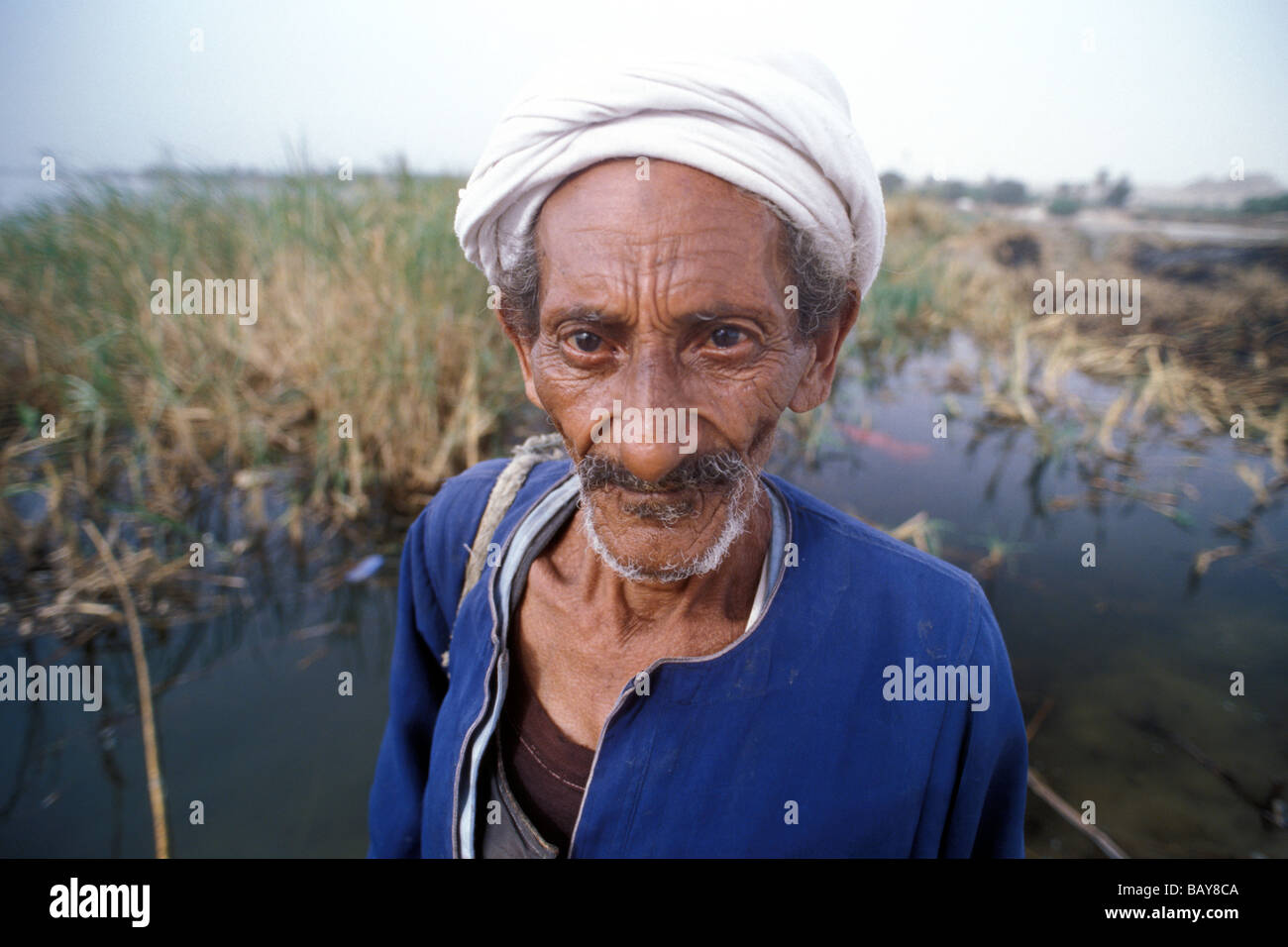 Mendicant fisherman near Minya, Egypt, fishing for Nile Perch with hook ...