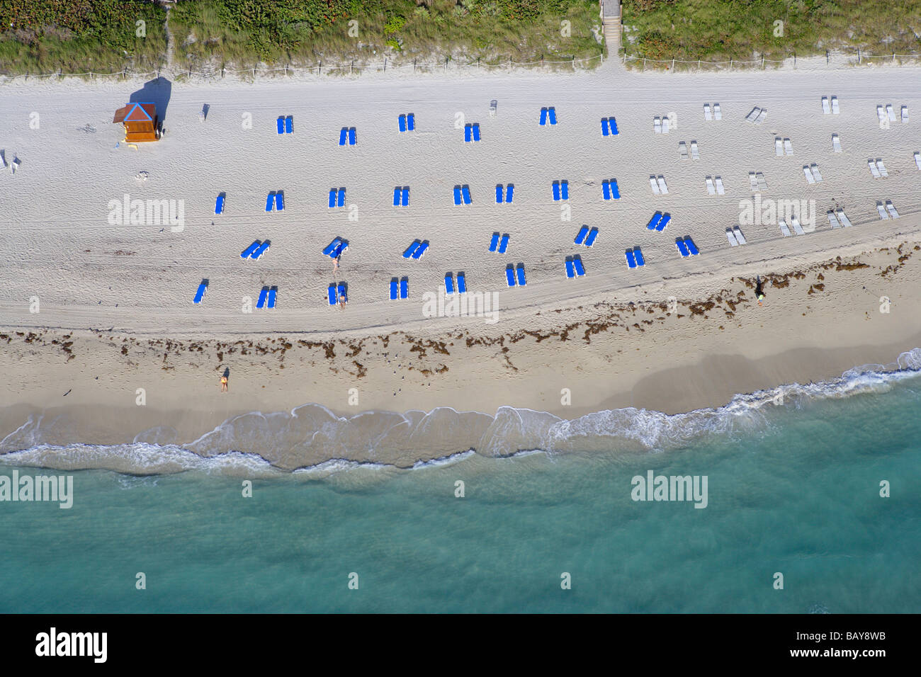 Sandy beach with sun loungers, Miami Beach, Boardwalk district, Florida ...