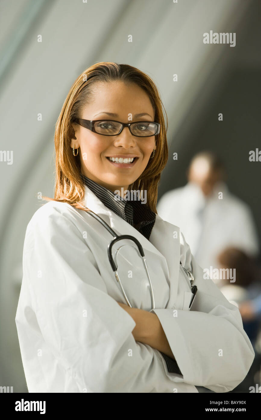 African doctor with arms crossed smiling Stock Photo - Alamy