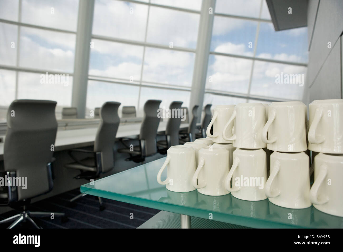 Stack of coffee mugs in conference room Stock Photo - Alamy