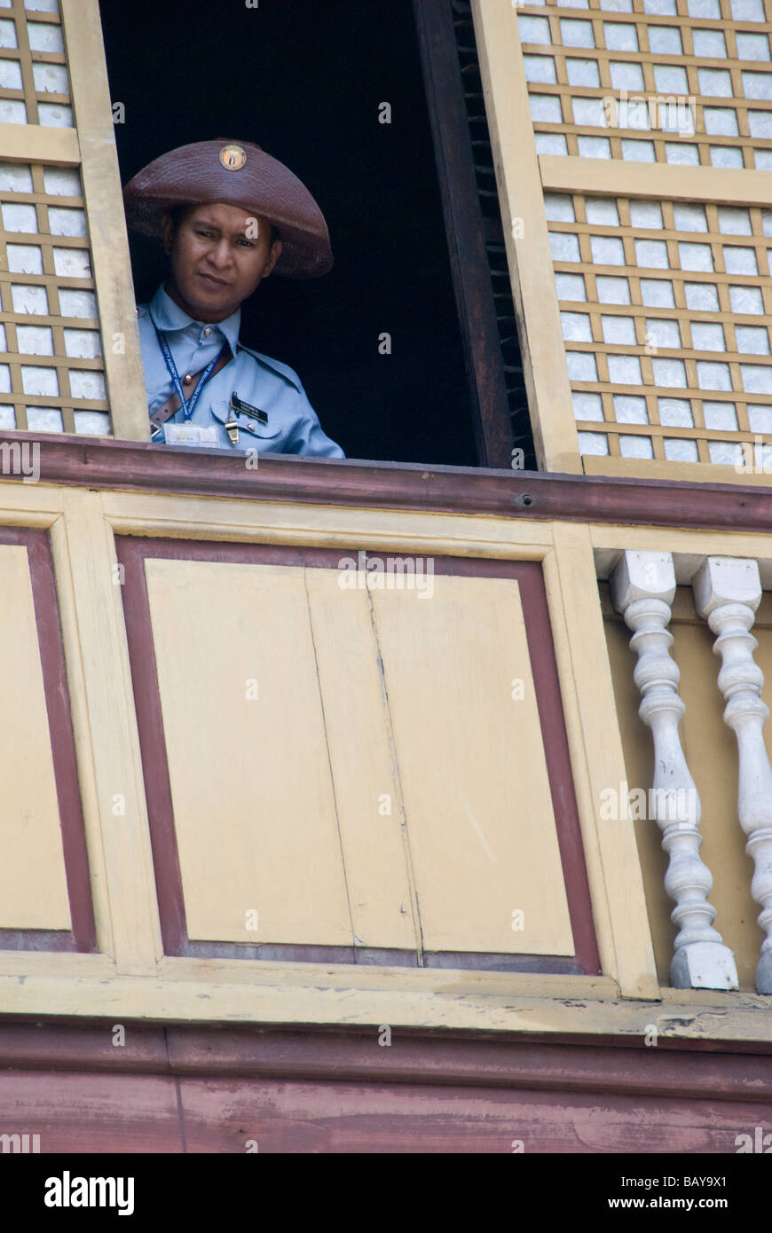Guard in traditional costume watches from a window at Casa Manila in ...