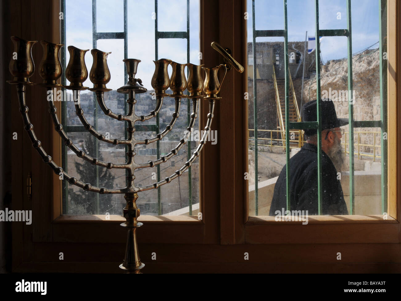 A religious Jewish man makes his way past a Menorah into the Tomb of ...