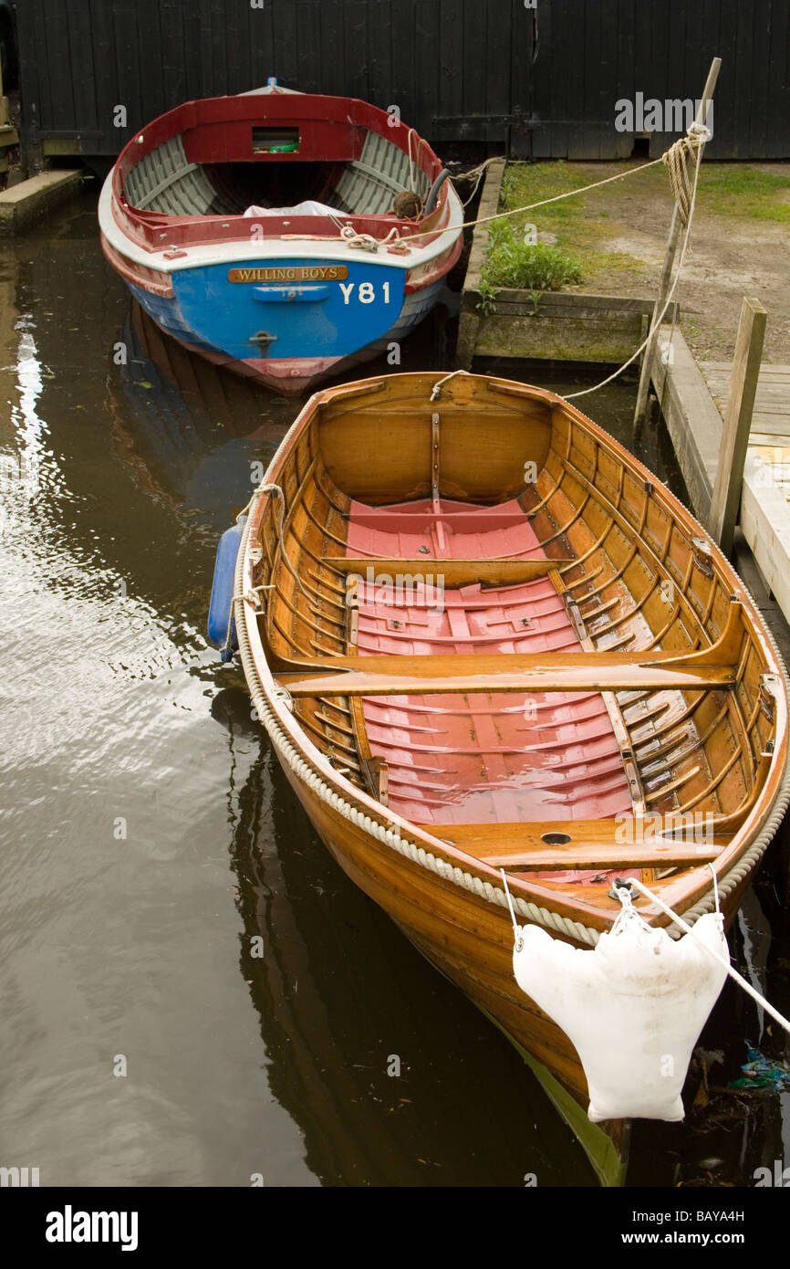 Small colourfull wooden dinghies tied up Stock Photo - Alamy