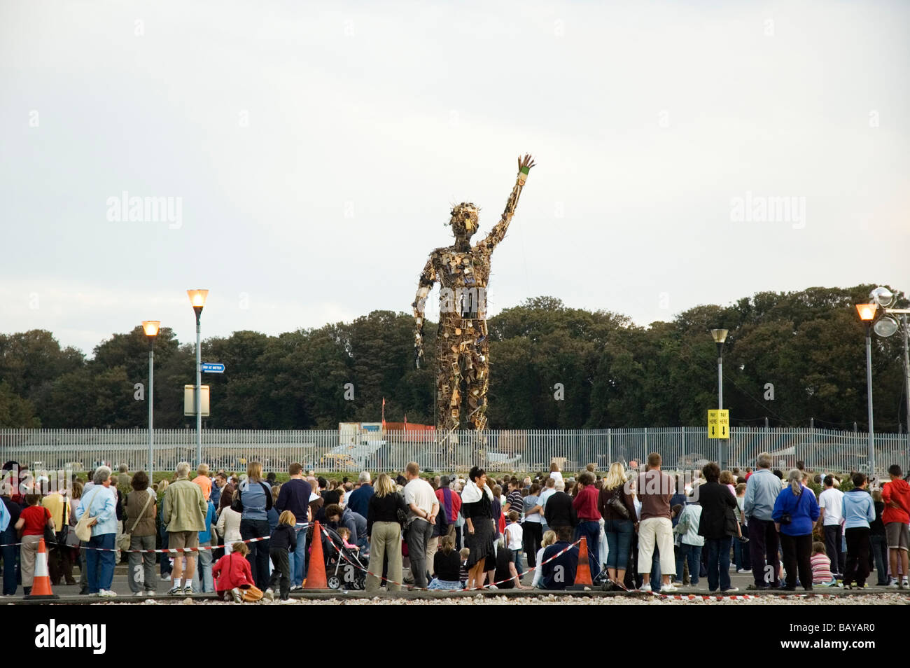 Crowds watching the Antony Gormley Waste Man structure prior to it ...