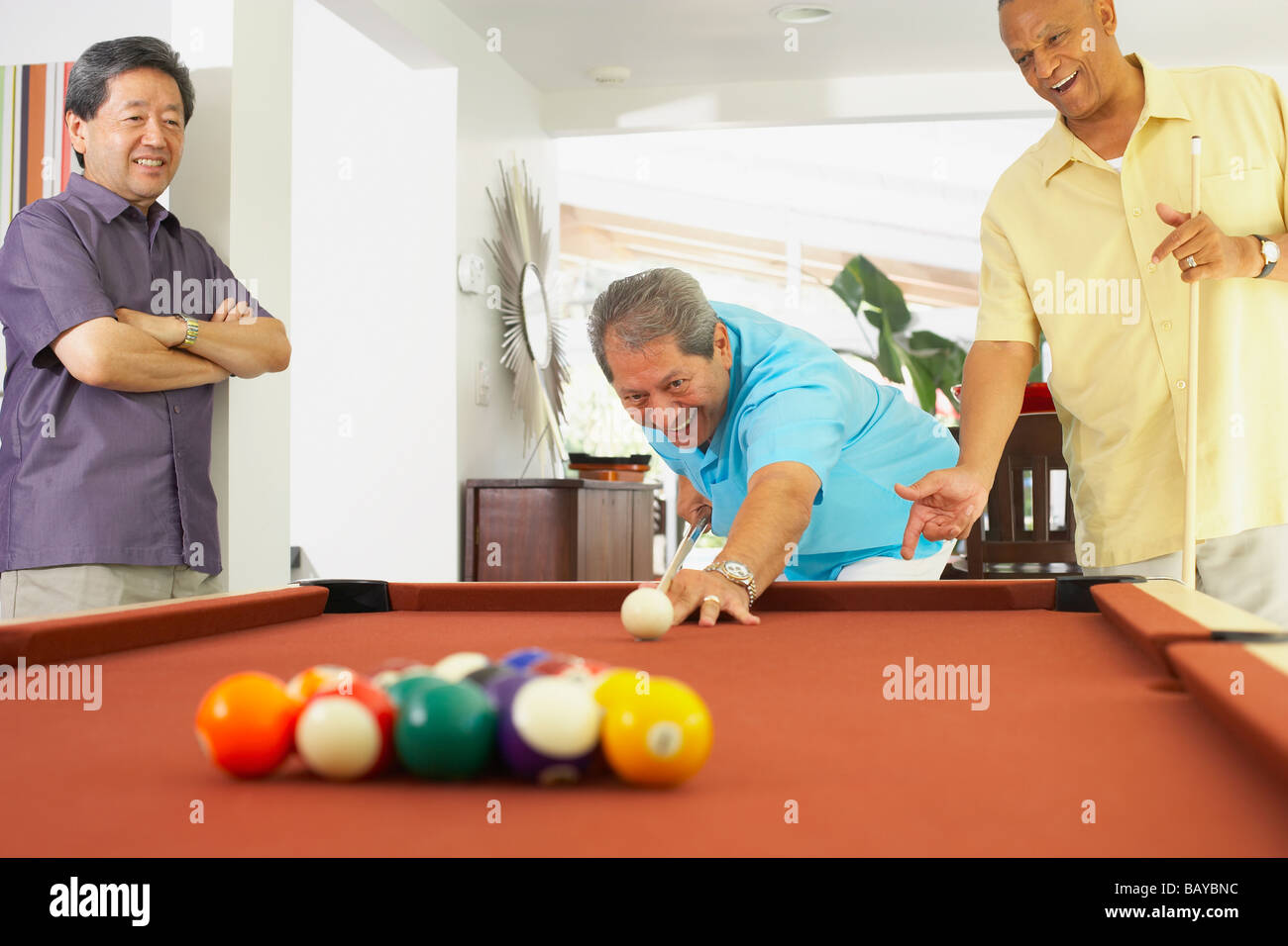 Multi-ethnic group of friends playing pool Stock Photo - Alamy