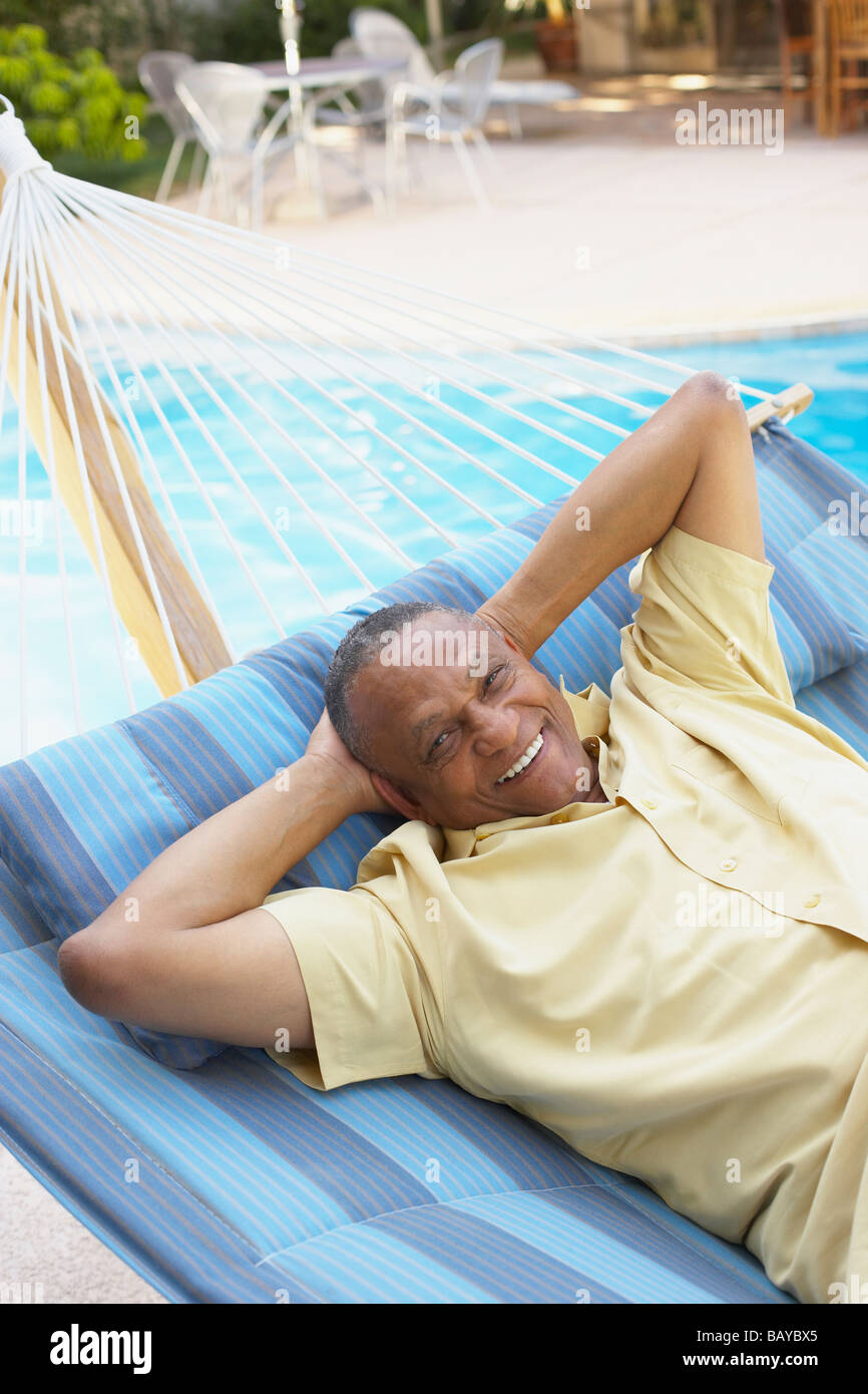 African man laying in hammock at poolside Stock Photo - Alamy