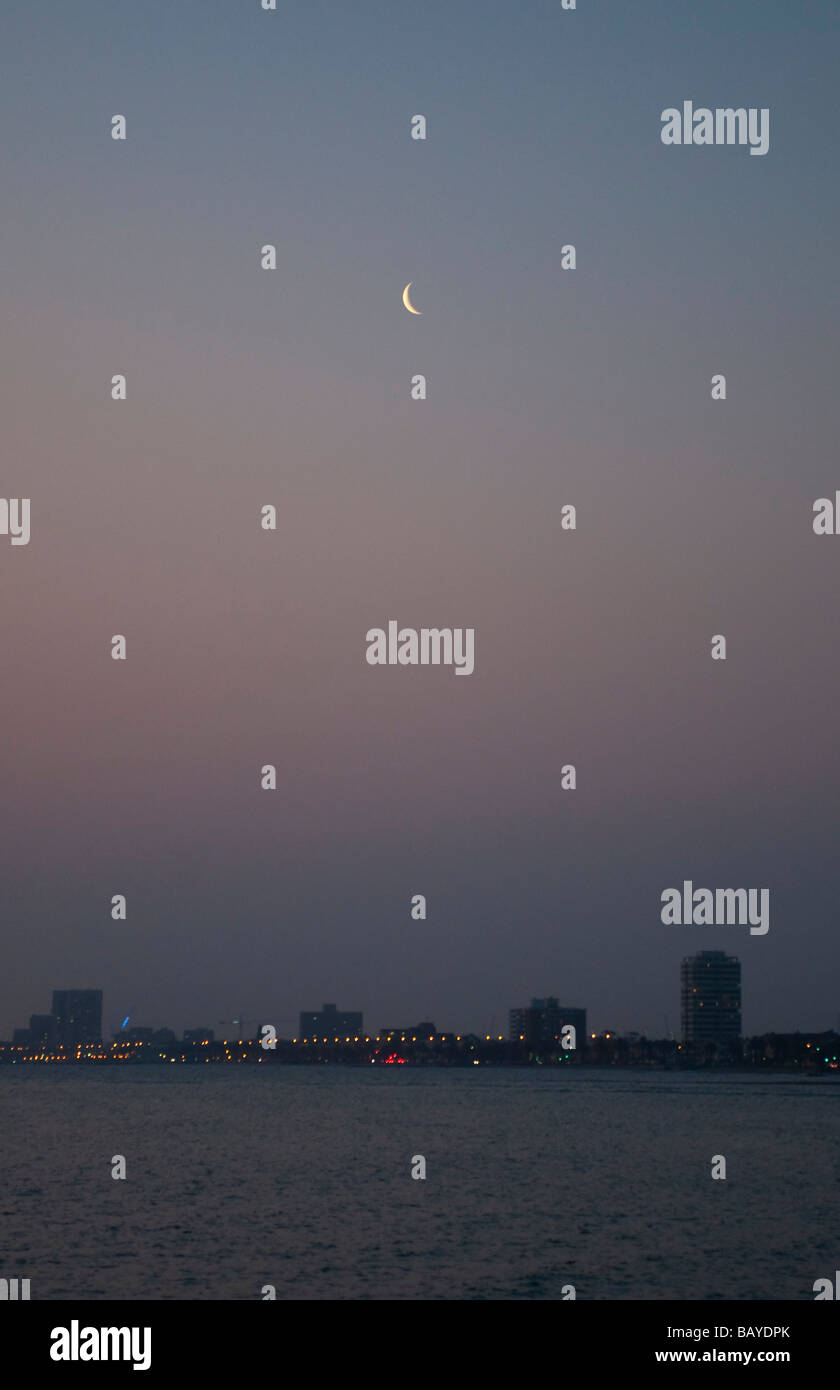 Crescent moon at dusk viewed from St Kilda beach Melbourne Victoria ...