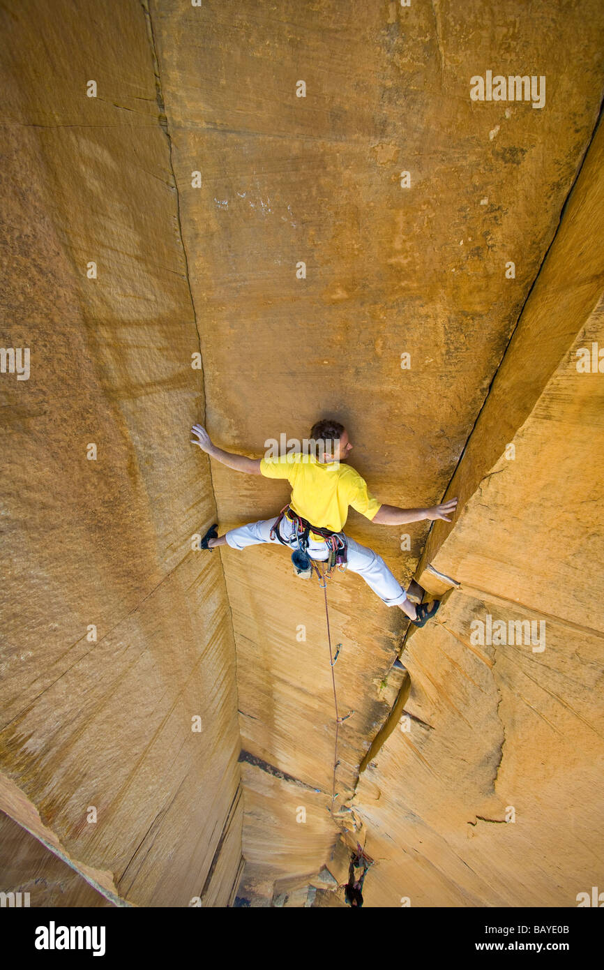 Climber stretches between two rock walls Stock Photo - Alamy