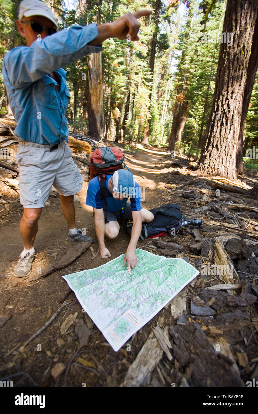 Two hikers consult their map along the trail Stock Photo - Alamy