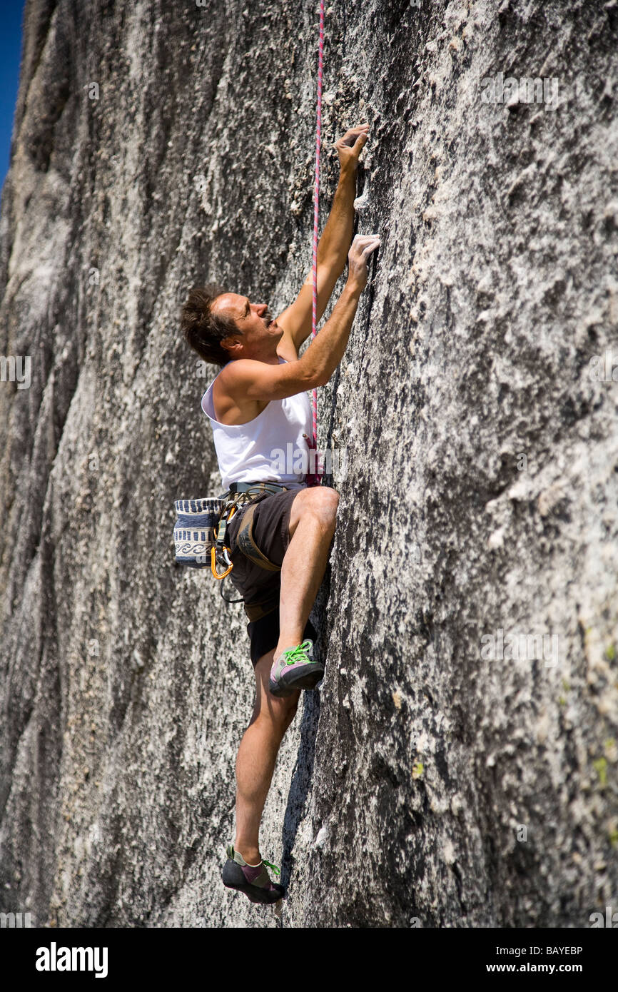 A rock climber scales a steep rock face Stock Photo - Alamy
