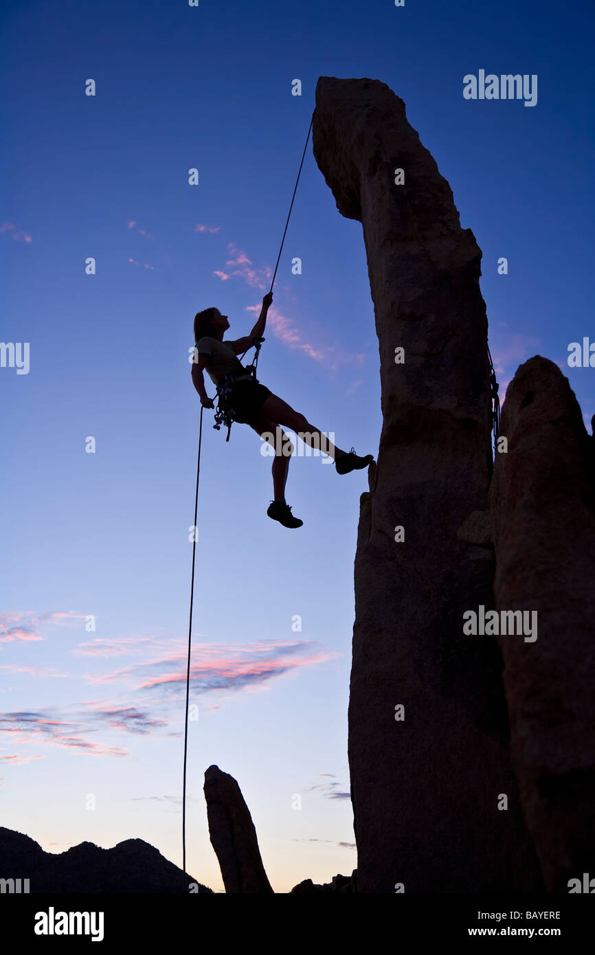 A rock climber rappelling from a rock spire Stock Photo - Alamy