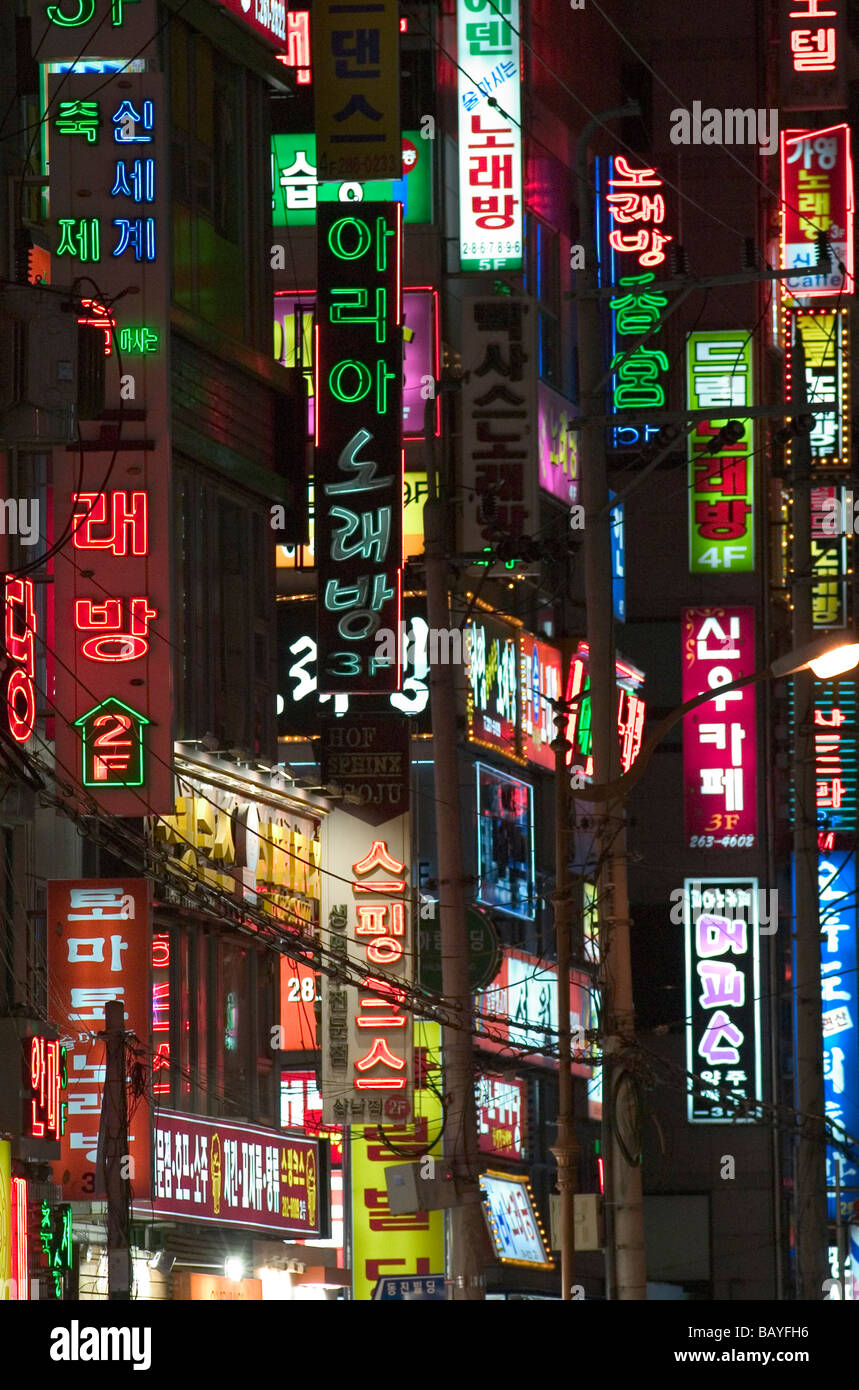 Neon signs and advertisements cover every inch of building fronts in ...