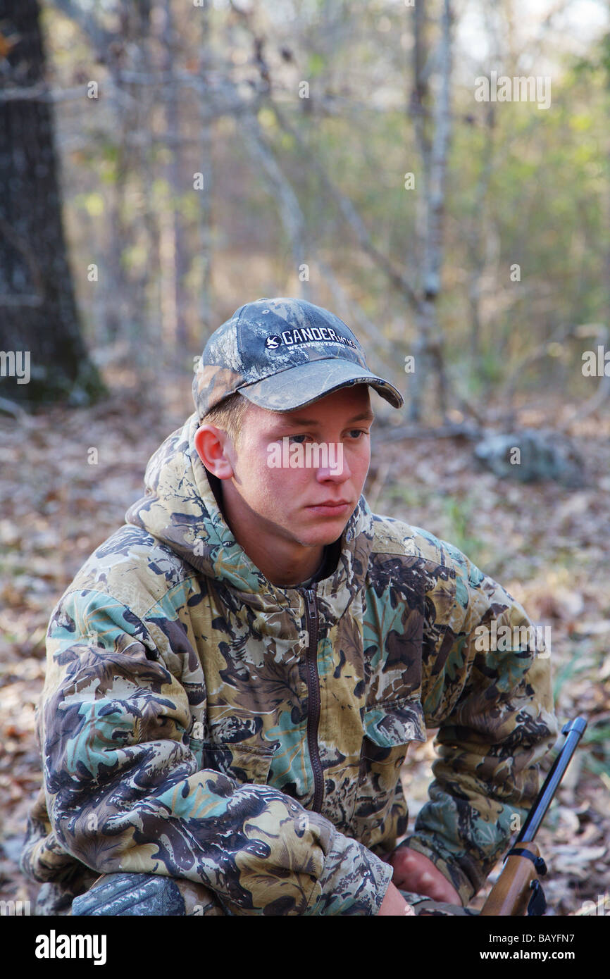 CLOSE UP PORTRAIT HUNTER KNEELING DOWN LOOKING LISTENING WATCHING FOR ...