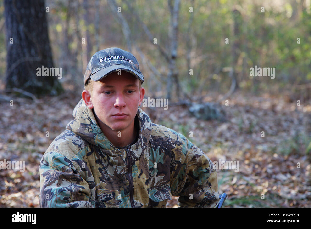 CLOSE UP PORTRAIT HUNTER KNEELING DOWN LOOKING LISTENING WATCHING FOR ...