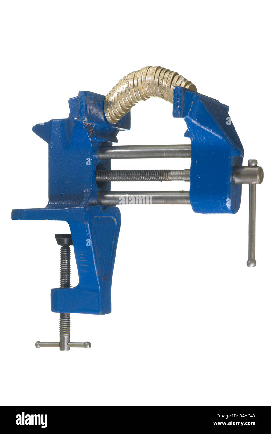 UK one pound coins being squeezed in a vice Stock Photo - Alamy