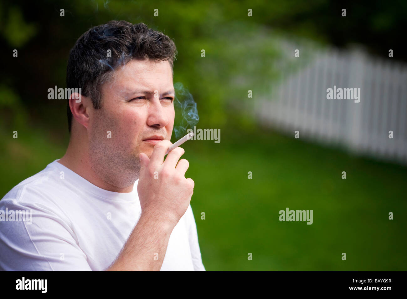Man smoking a cigarette outside Stock Photo - Alamy