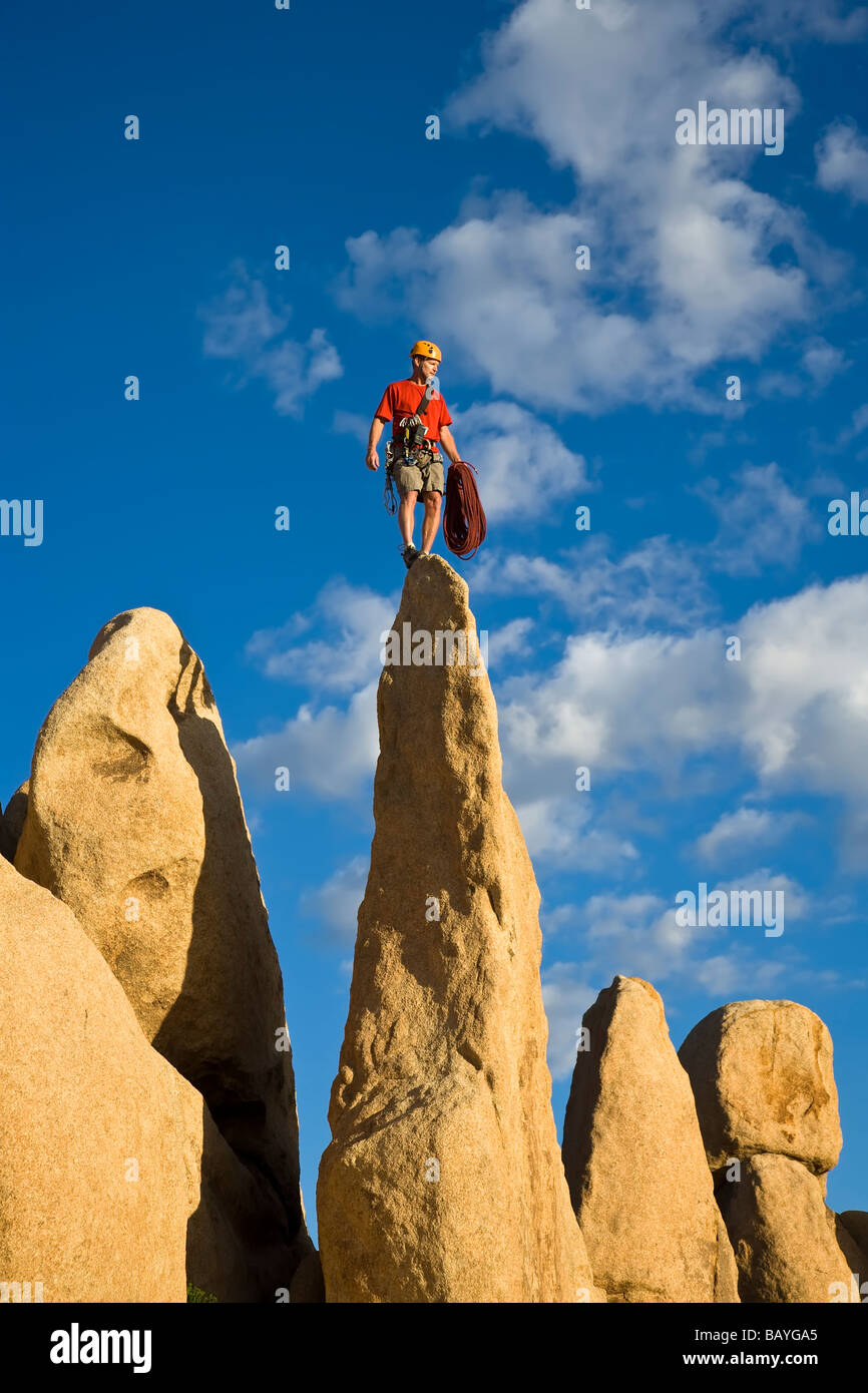 Climber on the summit of a rock spire Stock Photo - Alamy
