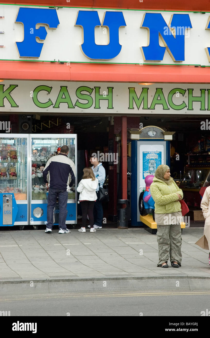 People waiting at a bus stop outside the Funland amusement arcade in ...