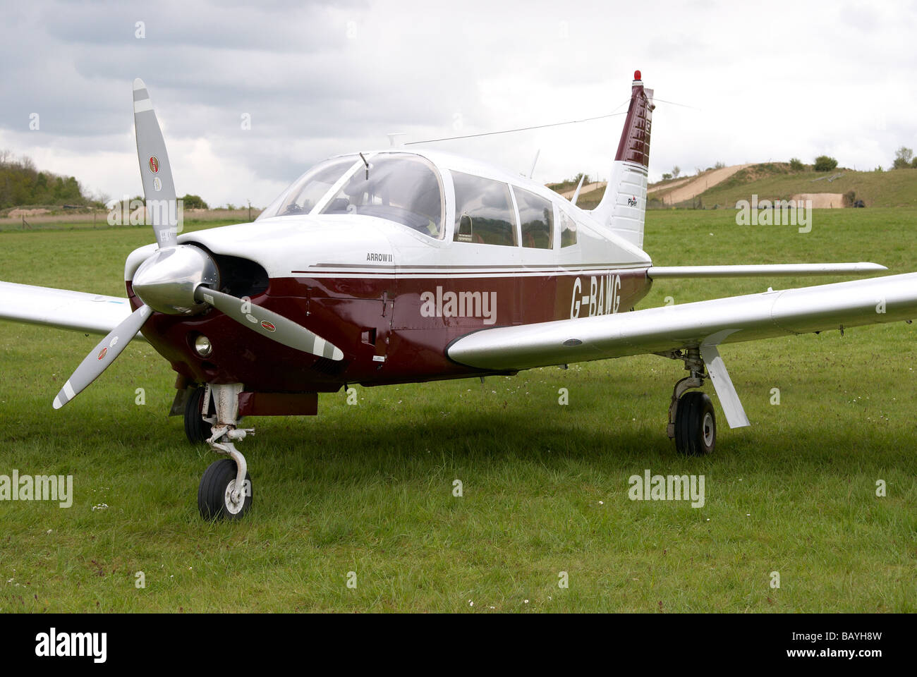 Piper Arrow III aircraft on grass airstrip in southern England Stock ...
