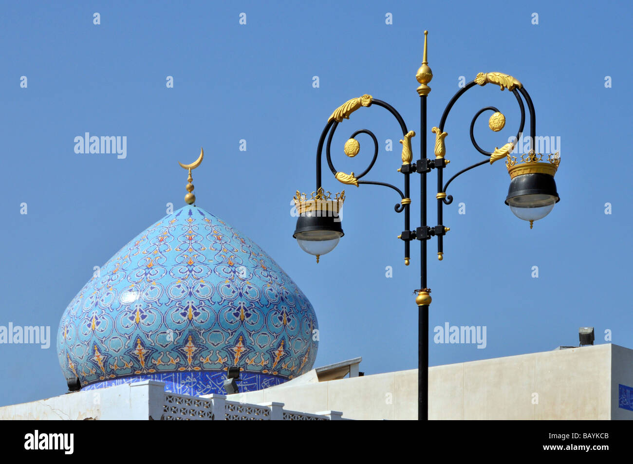 Muttrah Muscat decorated street lamp with dome of mosque beyond Oman ...