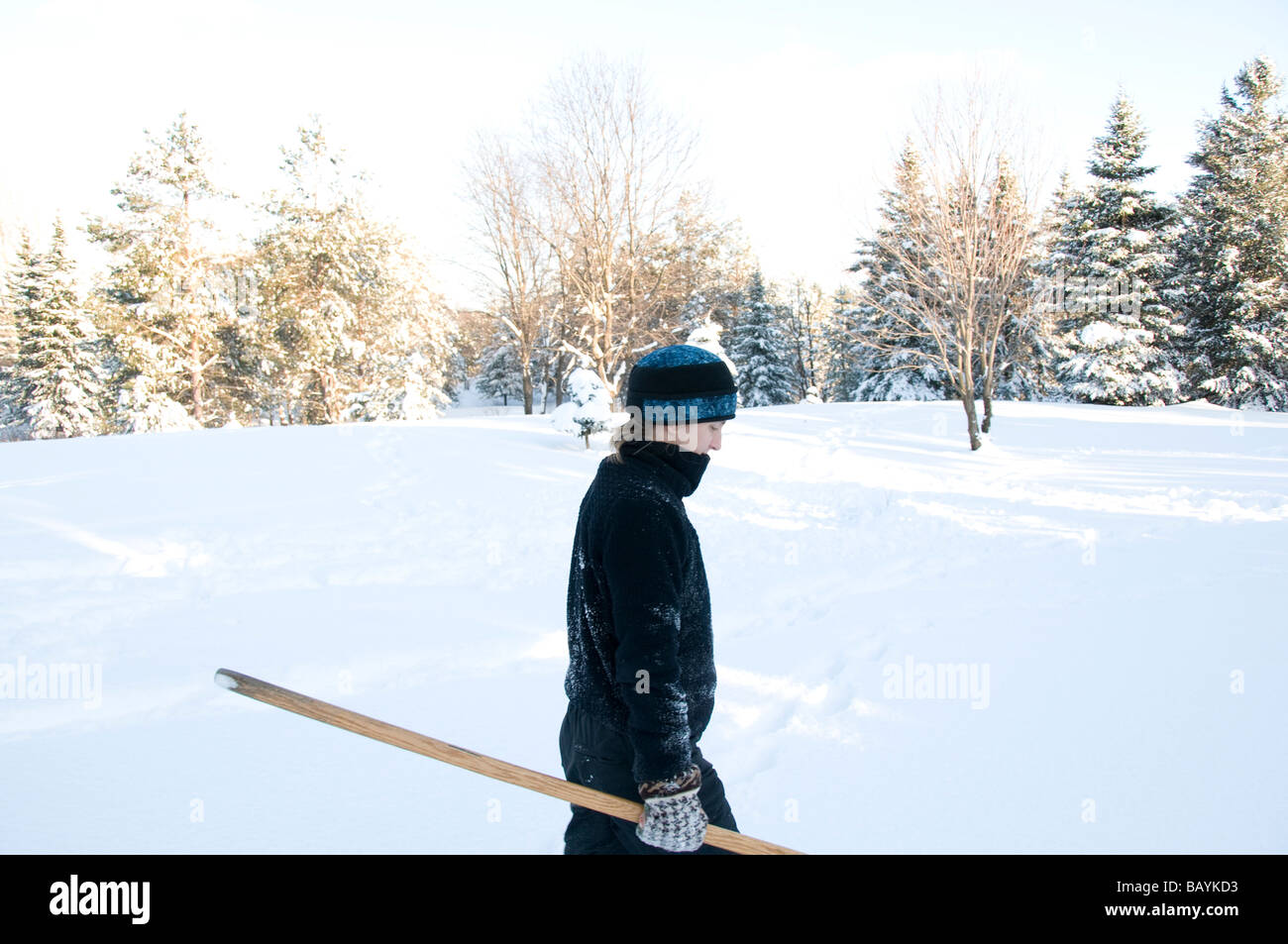 woman walking in snow with walking stick Stock Photo - Alamy