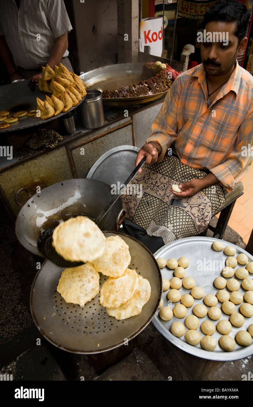 Indian man frying puri / poori bread in Shimla. Himachal Pradesh. India ...