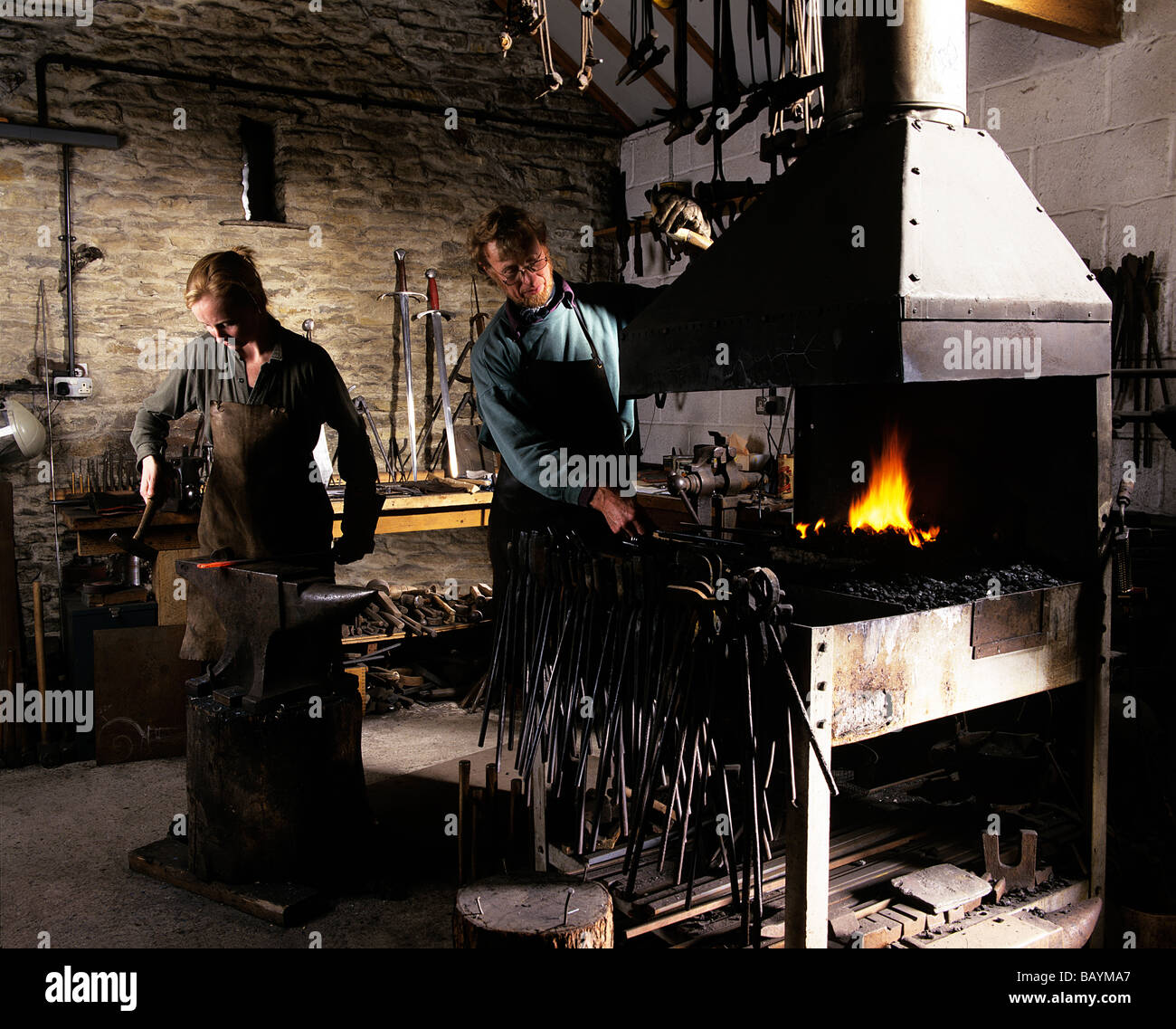 Blacksmiths in forge with furnace Stock Photo - Alamy