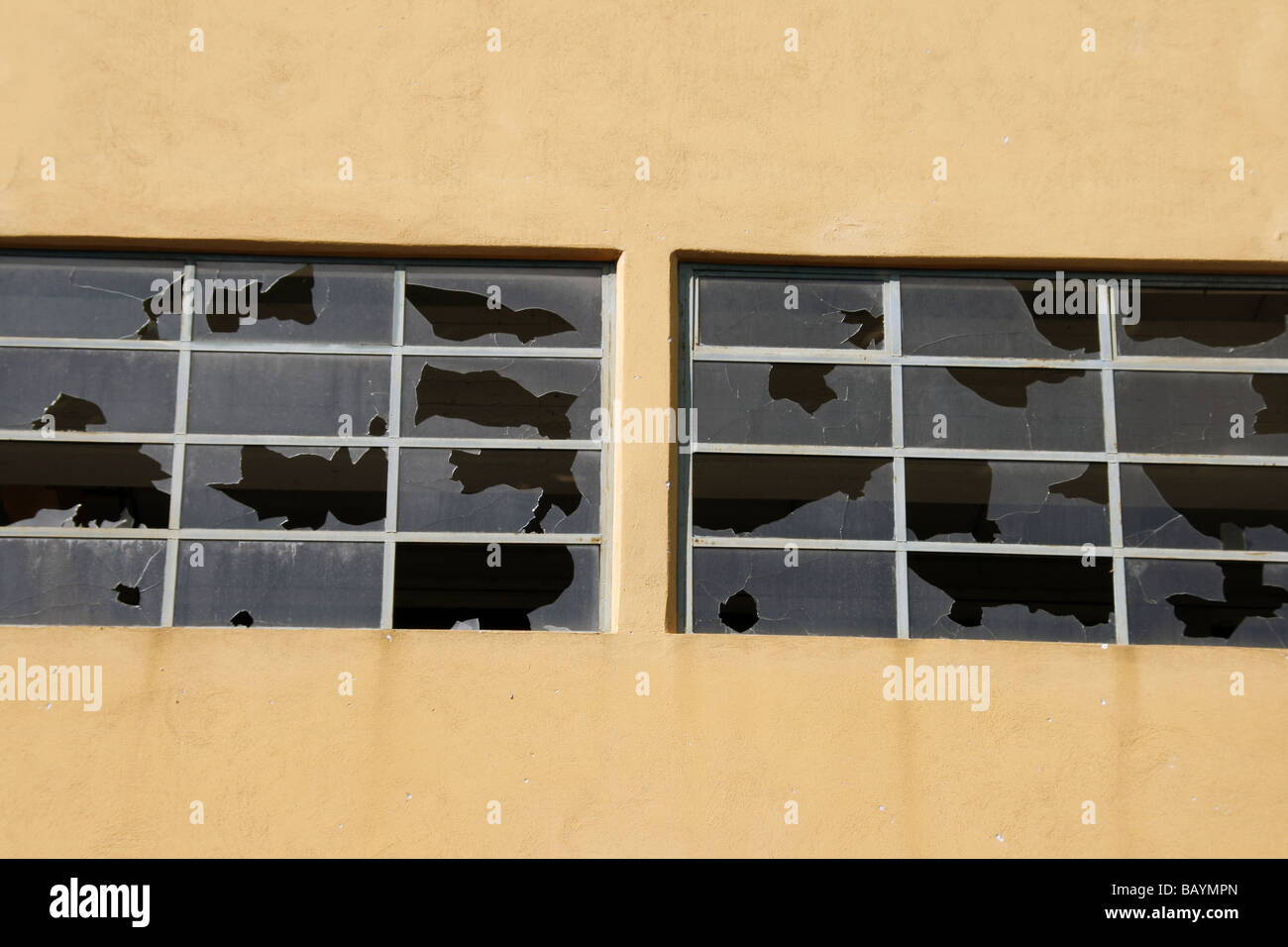 many broken windows on old derelict property building in sun Stock ...