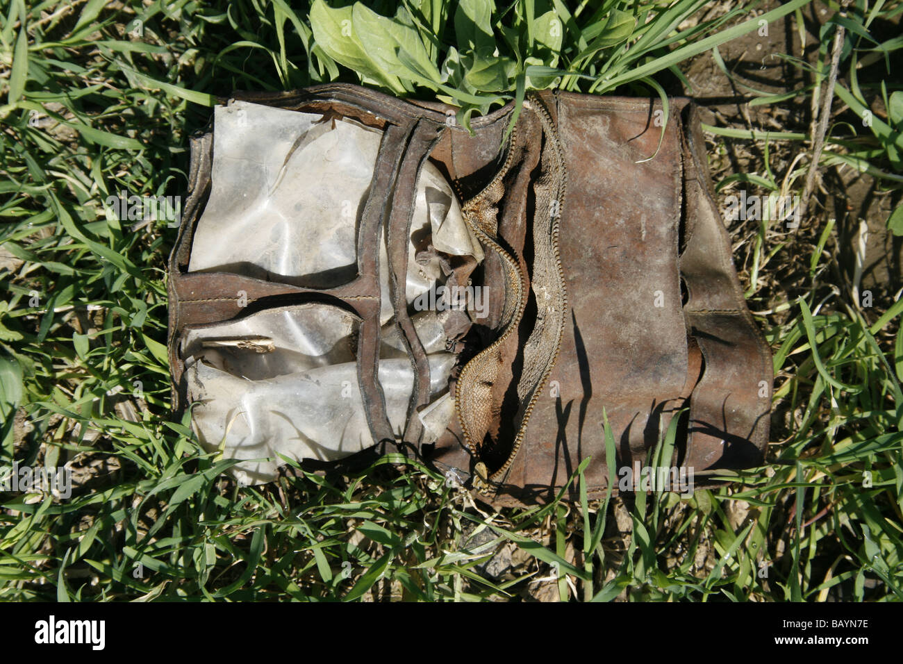 one old dirty damaged wallet left in field in country Stock Photo - Alamy
