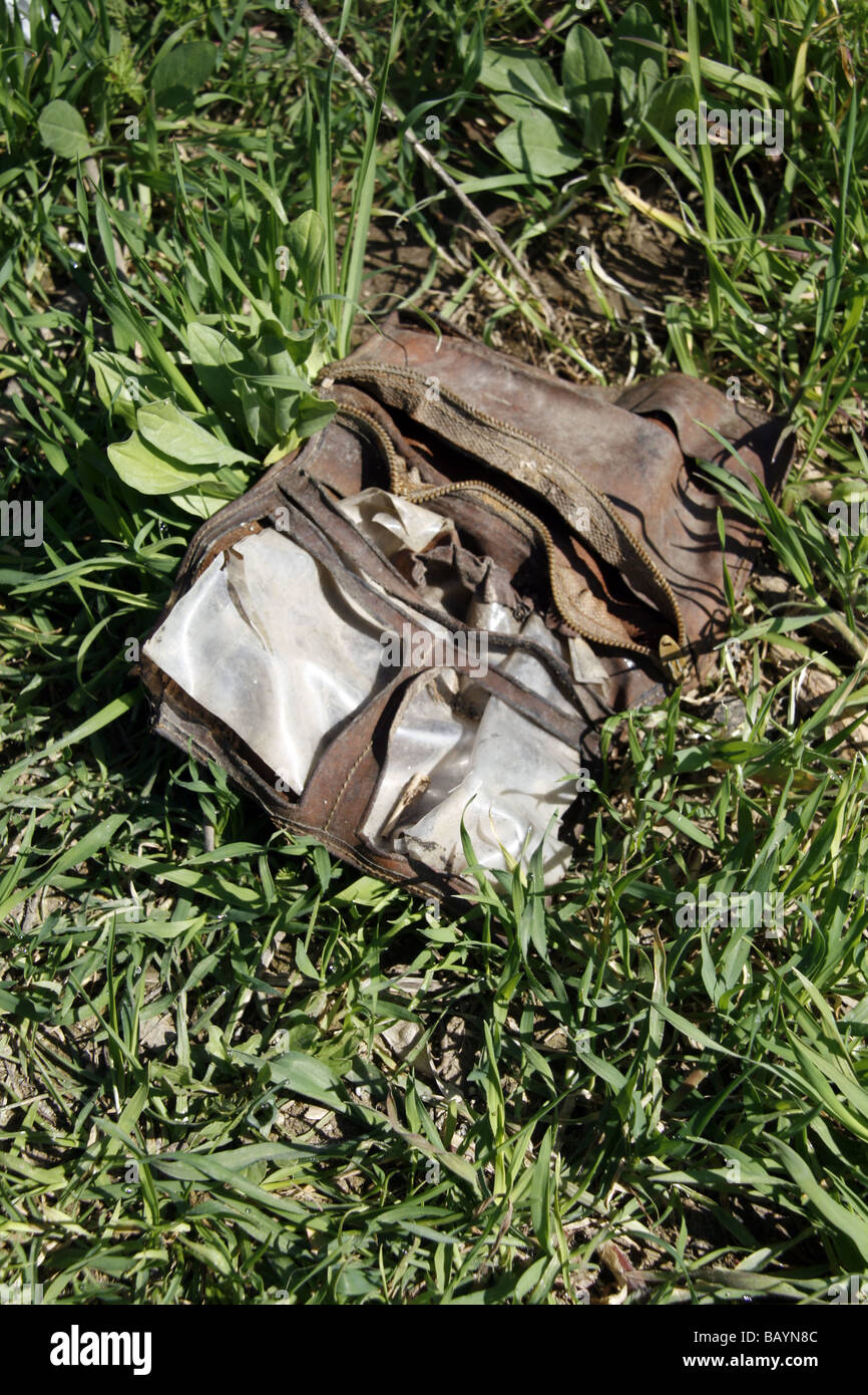 one old dirty damaged wallet left in field in country Stock Photo - Alamy