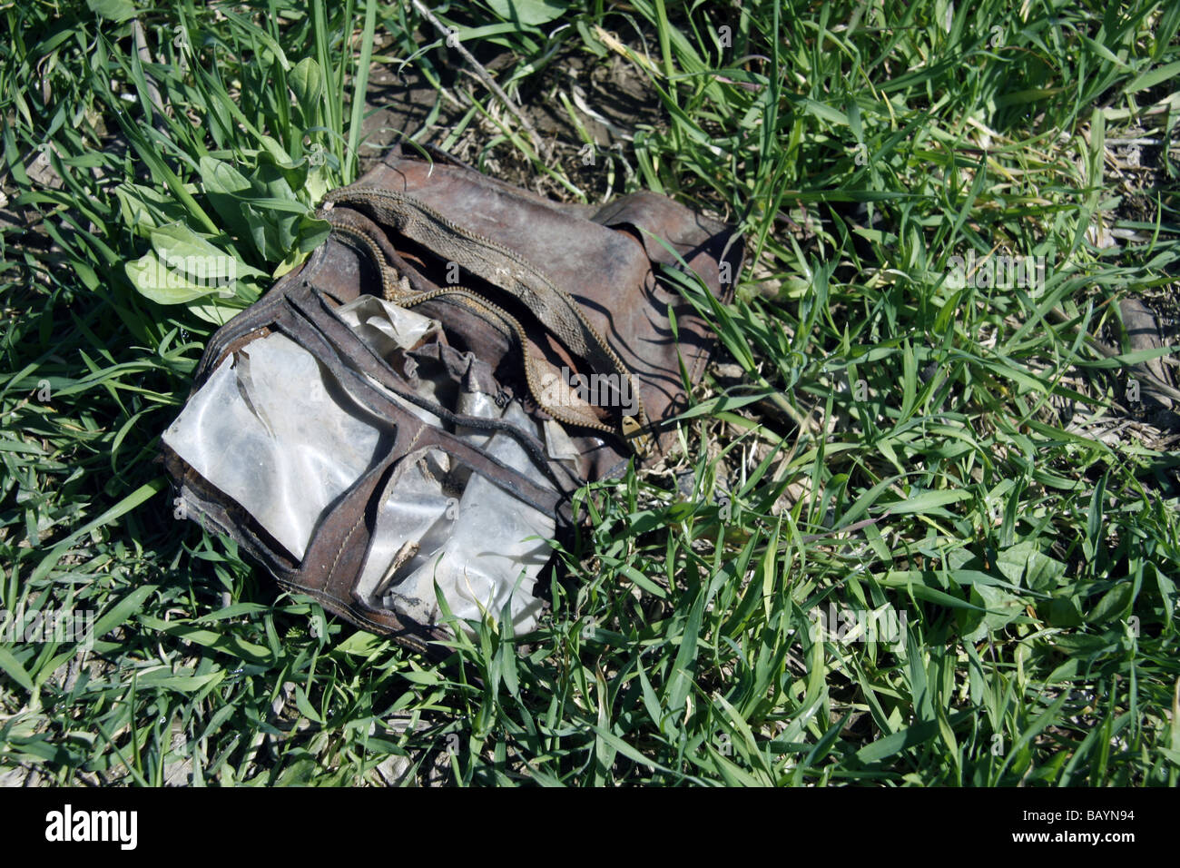 one old dirty damaged wallet left in field in country Stock Photo - Alamy