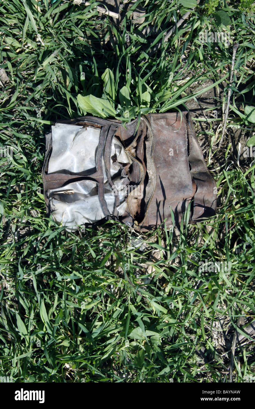 one old dirty damaged wallet left in field in country Stock Photo - Alamy
