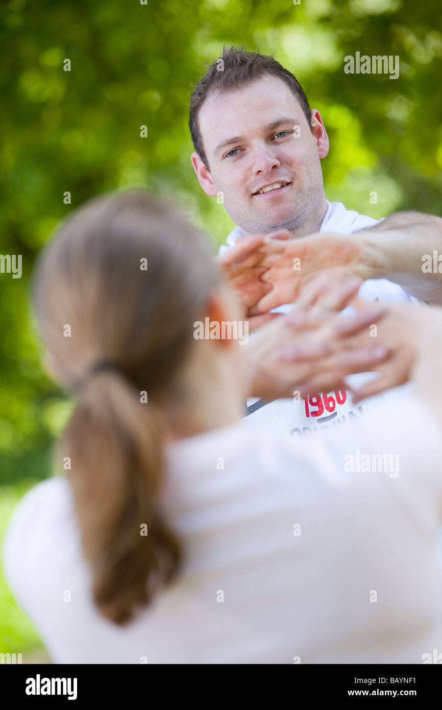 A male physical training instructor with a female student outside ...