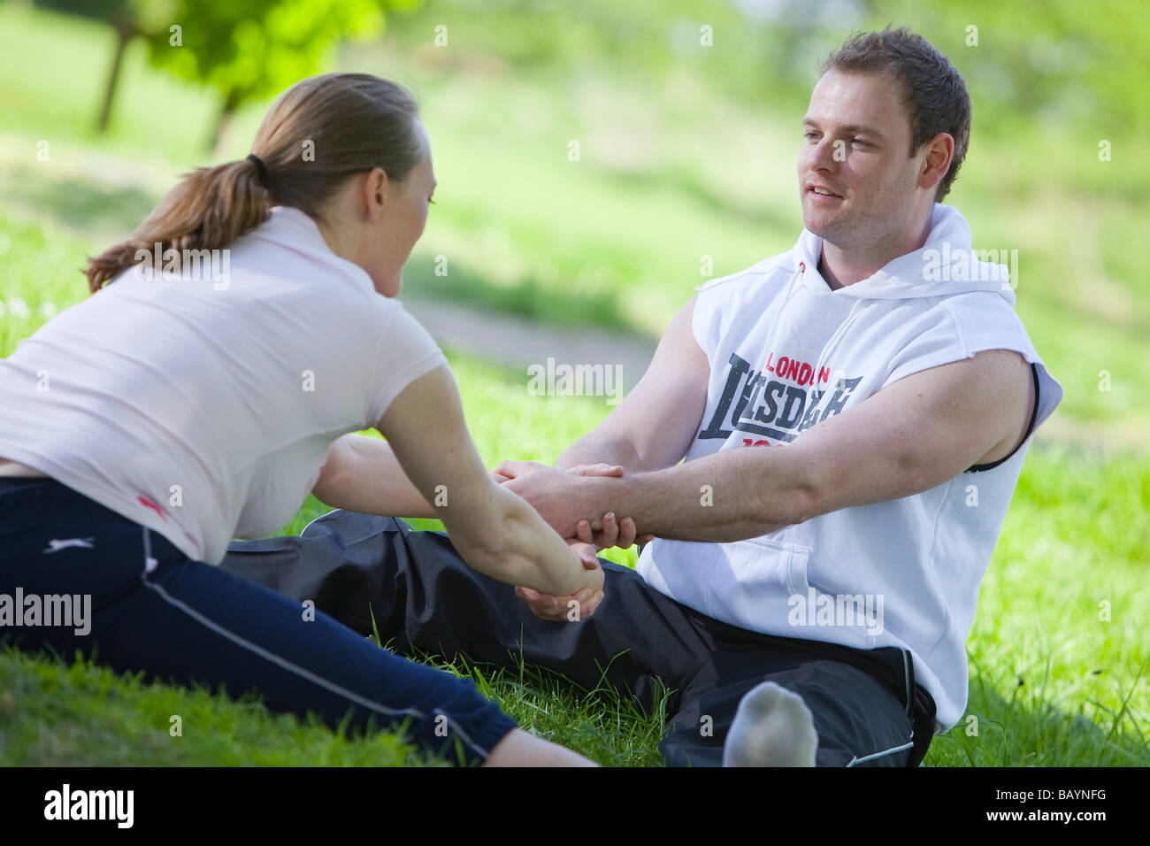 A male physical training instructor with a female student outside ...