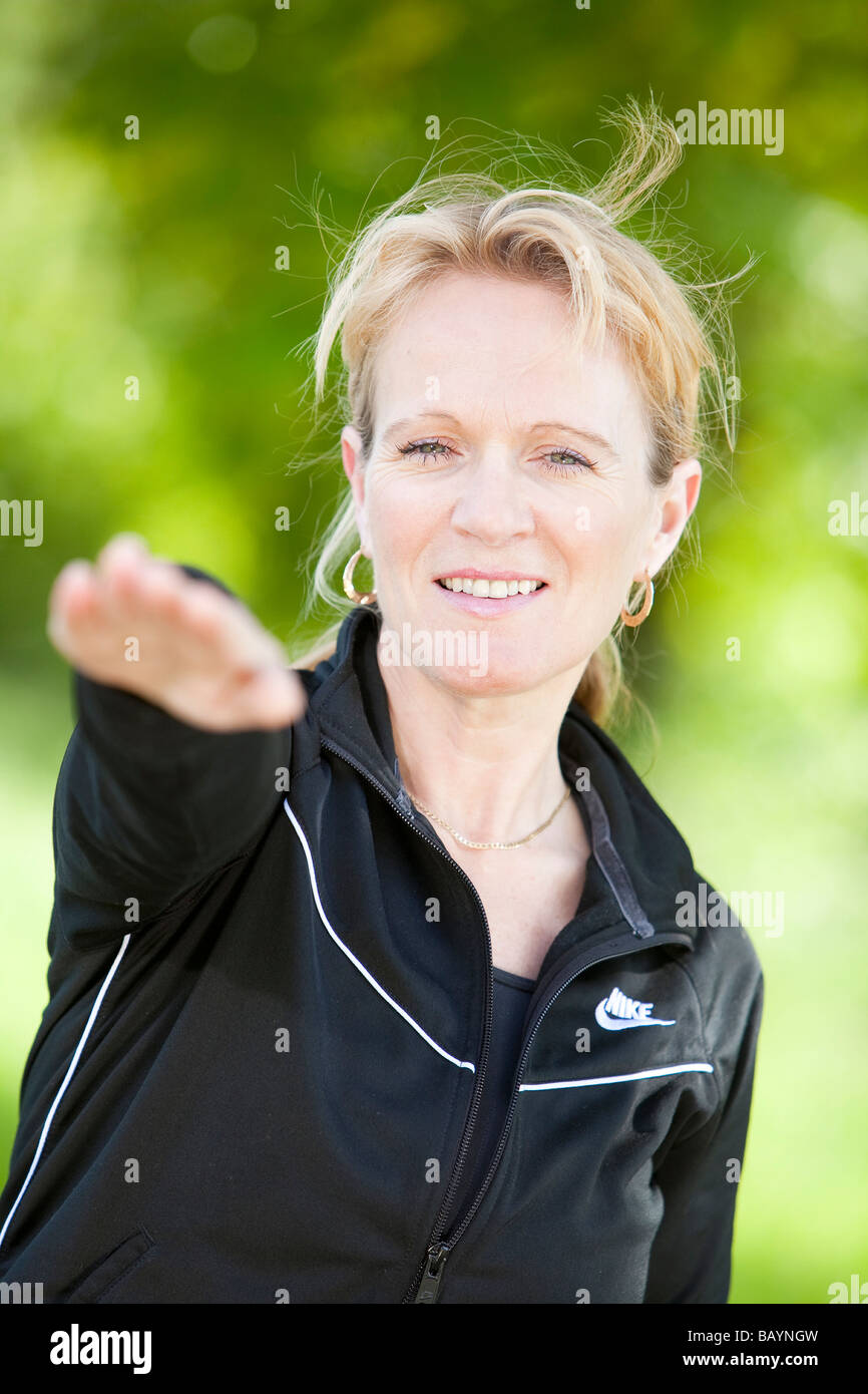 A female yoga instructor during an outdoor class in the English ...