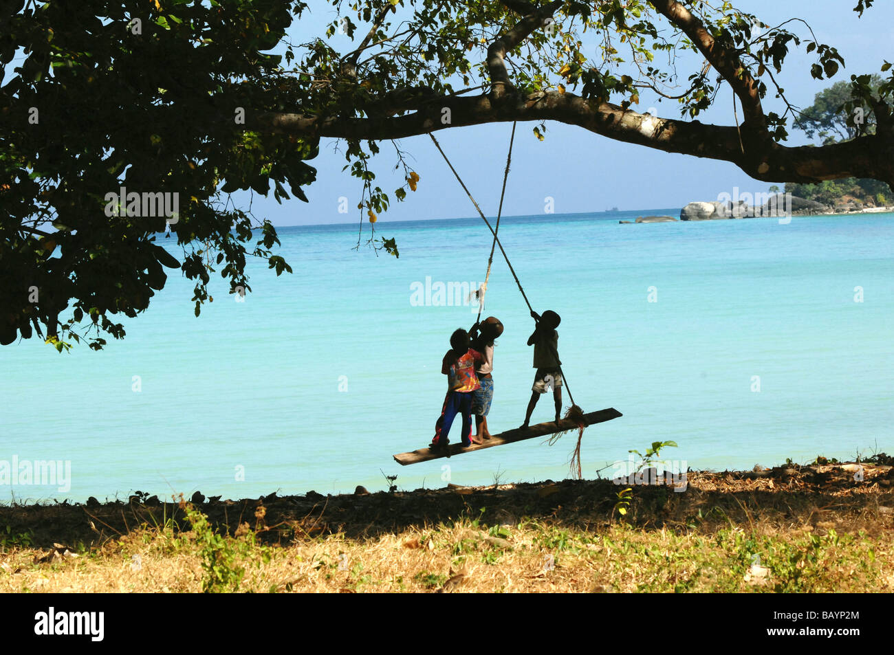 Moken kids enjoy playing with swing by the beach near thier village,Koh ...