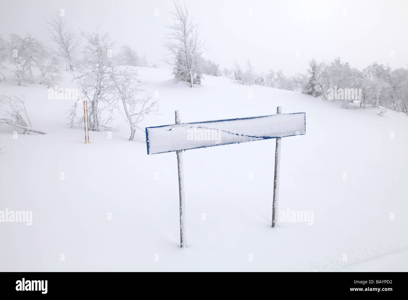 Sign covered by snow Stock Photo - Alamy