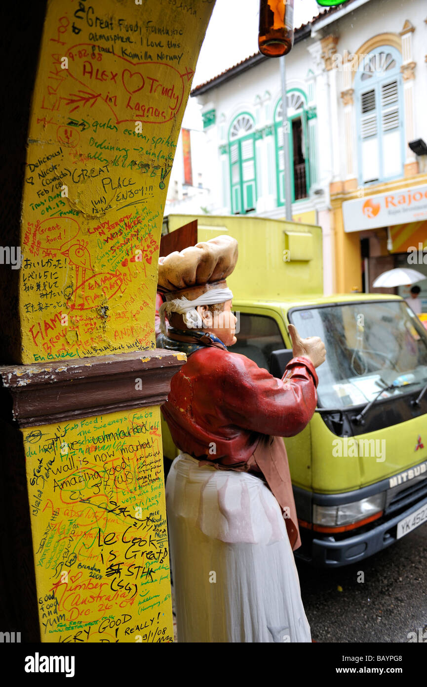 Life size statue of a cook or baker standing beside graffiti covered ...