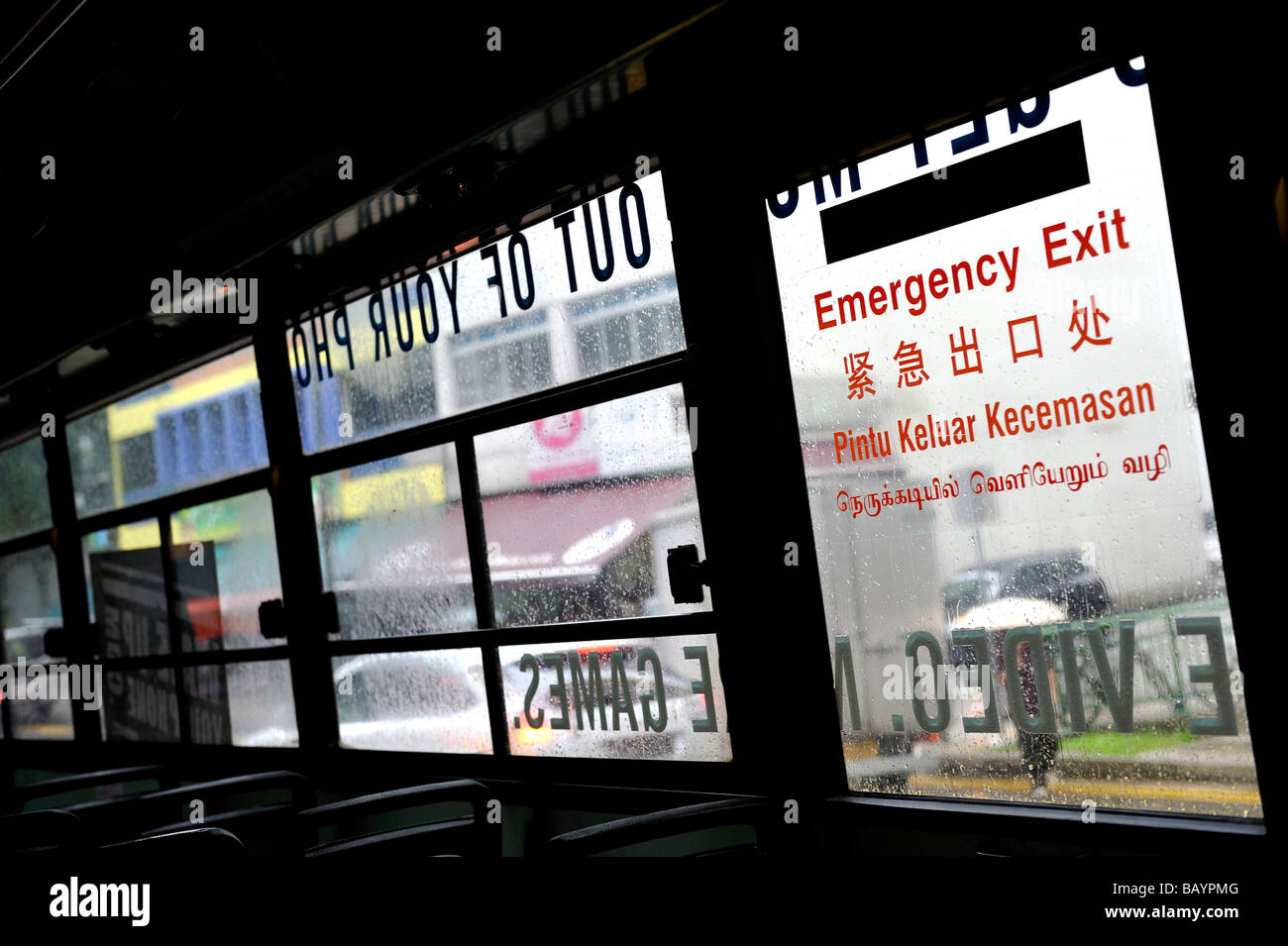 Multi lingual "Emergency Exit" sign on window of public transport bus ...