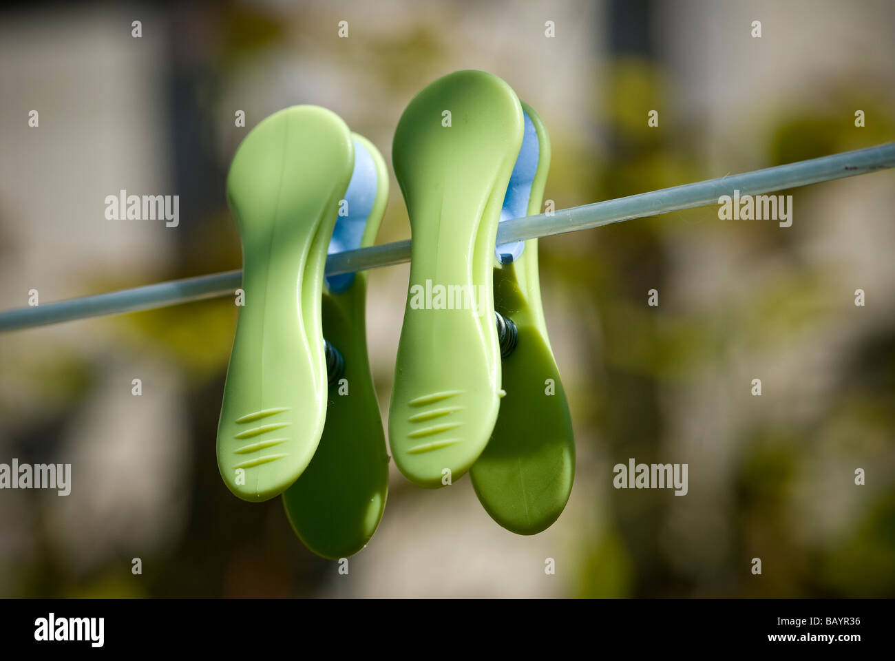 Green plastic washing pegs on a washing line Stock Photo - Alamy