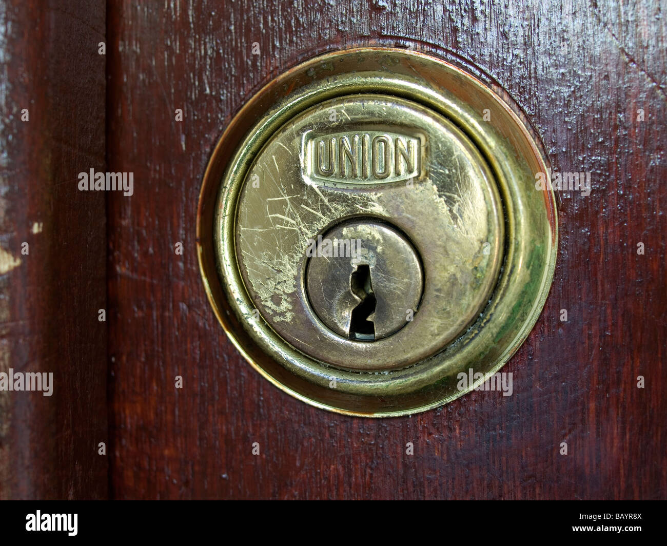 Union brand Yale type lock in a wooden door scratched and worn with use ...