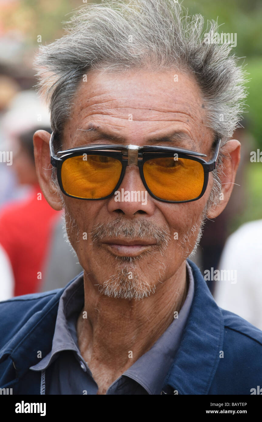 Chinese man with tinted sunglasses in Jianshui China Stock Photo - Alamy
